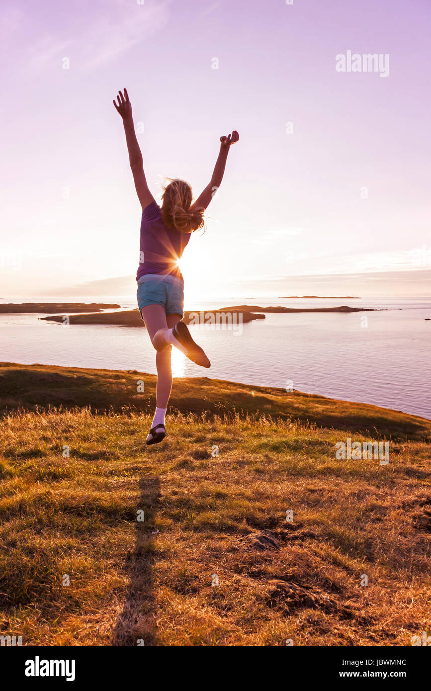 Young girl enjoying life in a beautiful sunset Stock Photo - Alamy