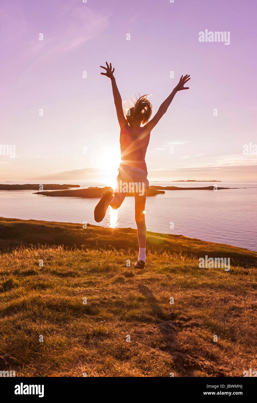 Young girl enjoying life in a beautiful sunset Stock Photo - Alamy