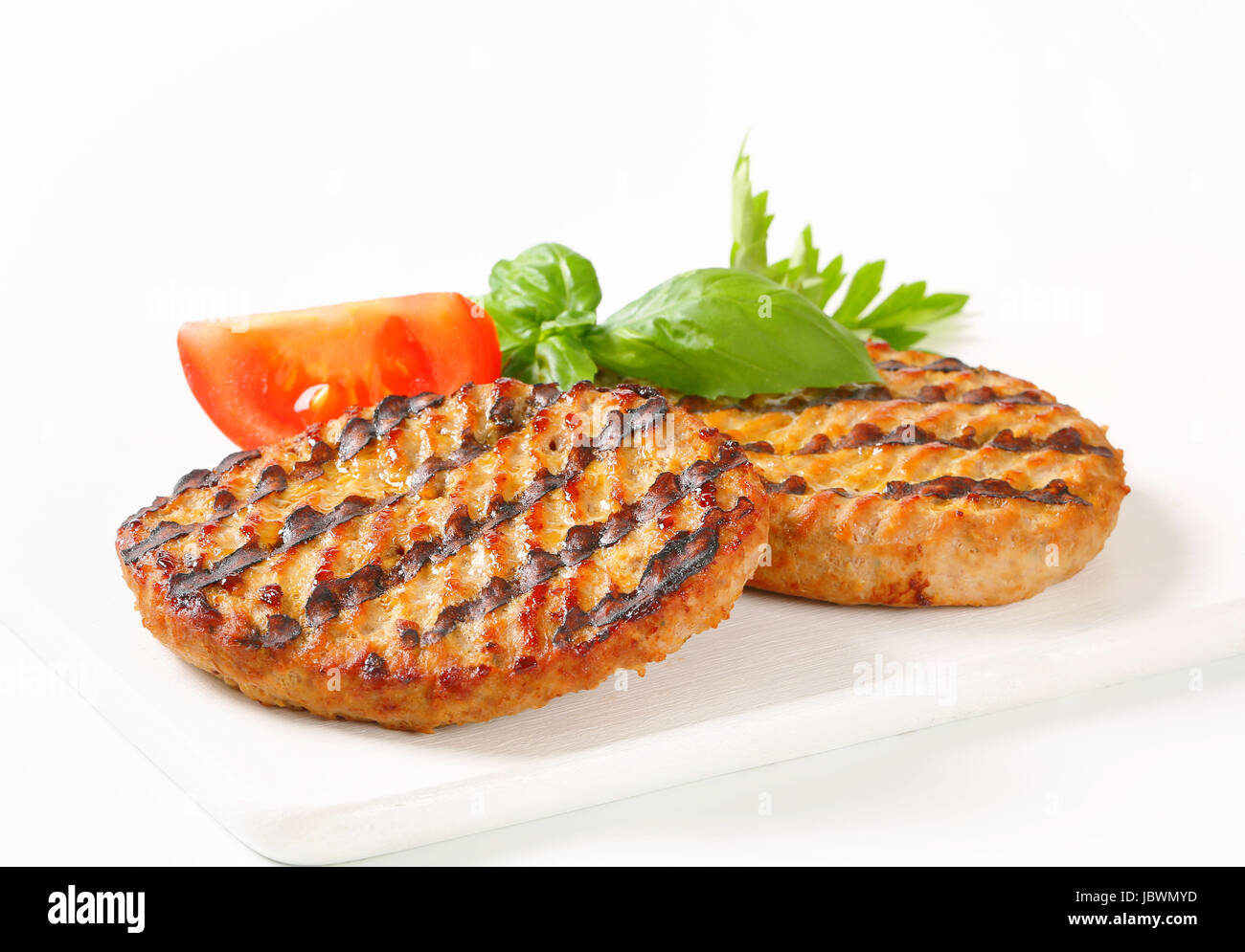 Grilled patties on cutting board Stock Photo - Alamy