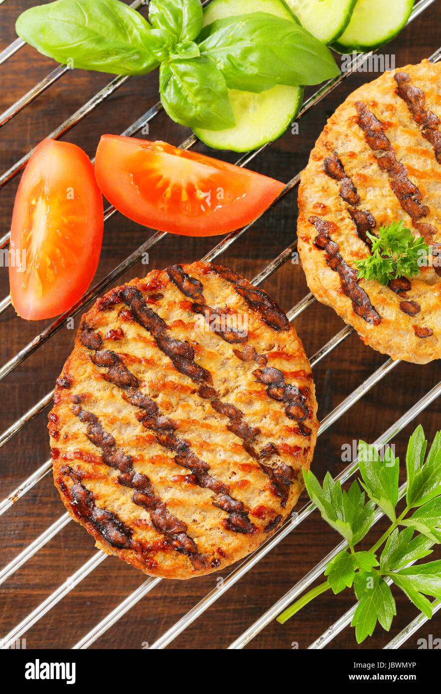 Grilled patties on barbecue grid Stock Photo - Alamy