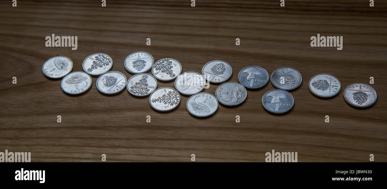 Anniversary lat coins of an old Latvian currency on a wooden background ...