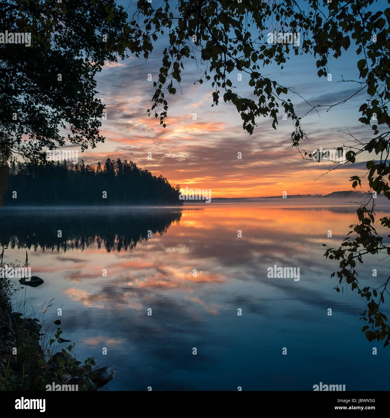 Scenic landscape with lake and beautiful sunrise at morning Stock Photo ...