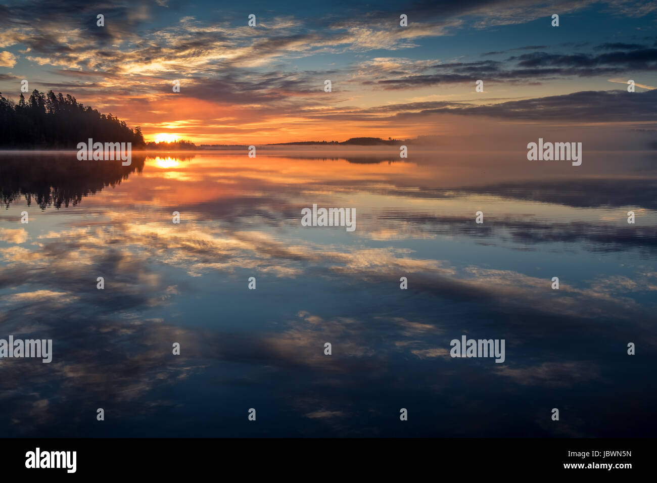 Scenic landscape with lake and beautiful sunrise at morning Stock Photo ...