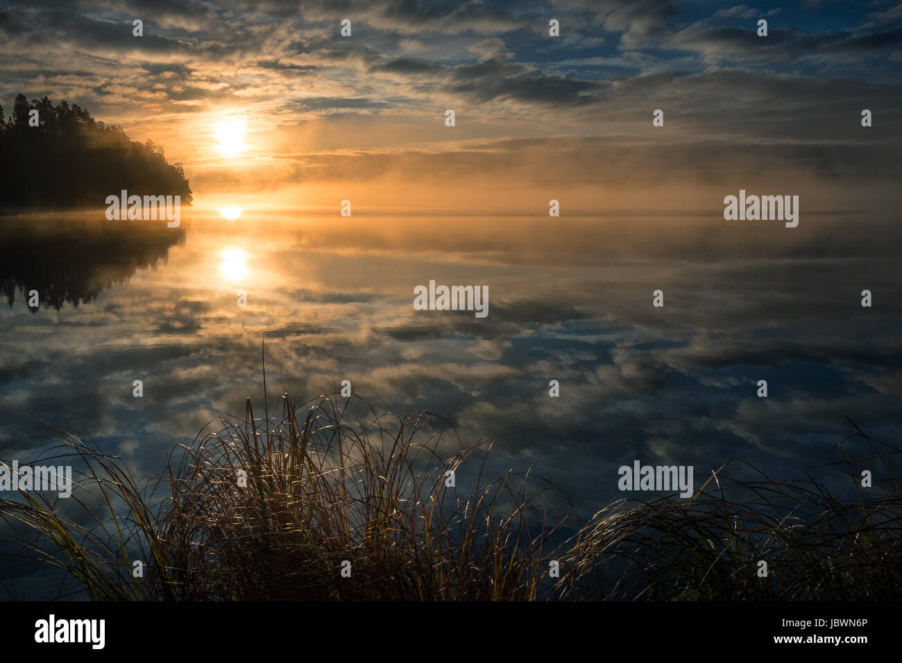 Scenic landscape with lake and beautiful sunrise at morning Stock Photo ...