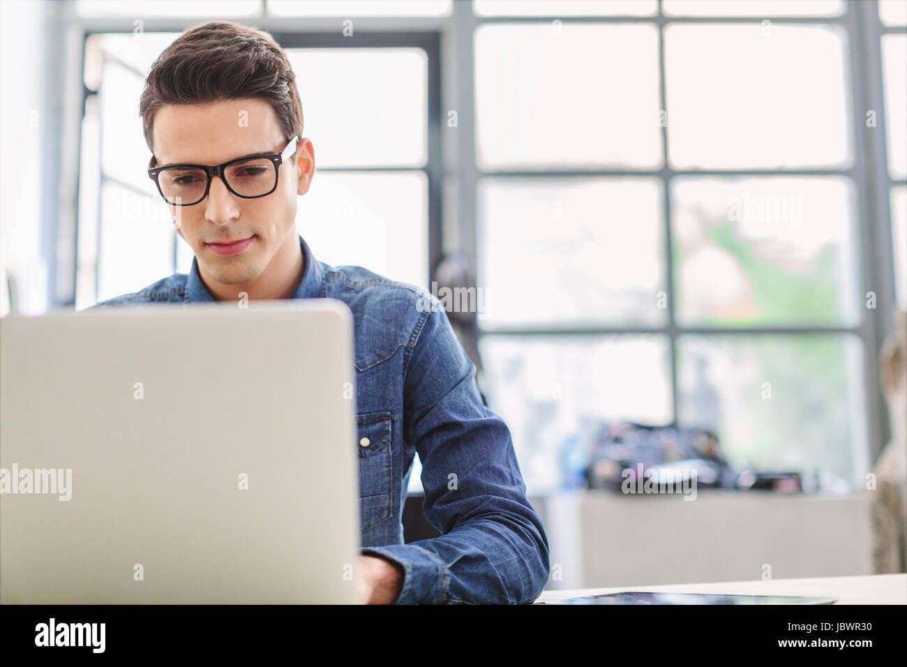 Man working at laptop Stock Photo - Alamy