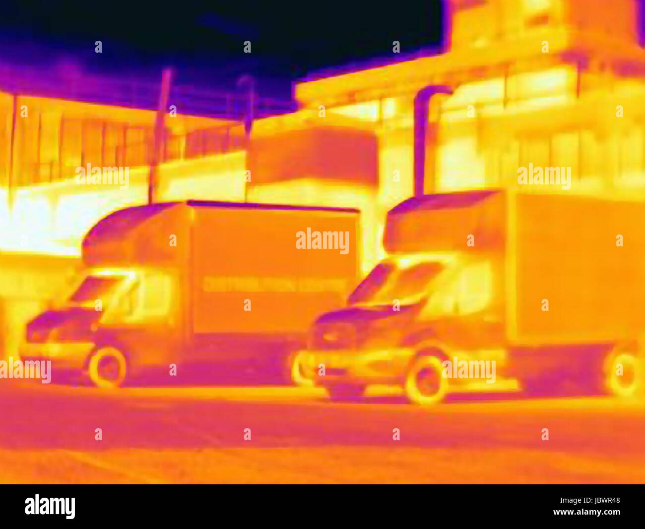 Thermal image of two trucks outside industrial building Stock Photo - Alamy