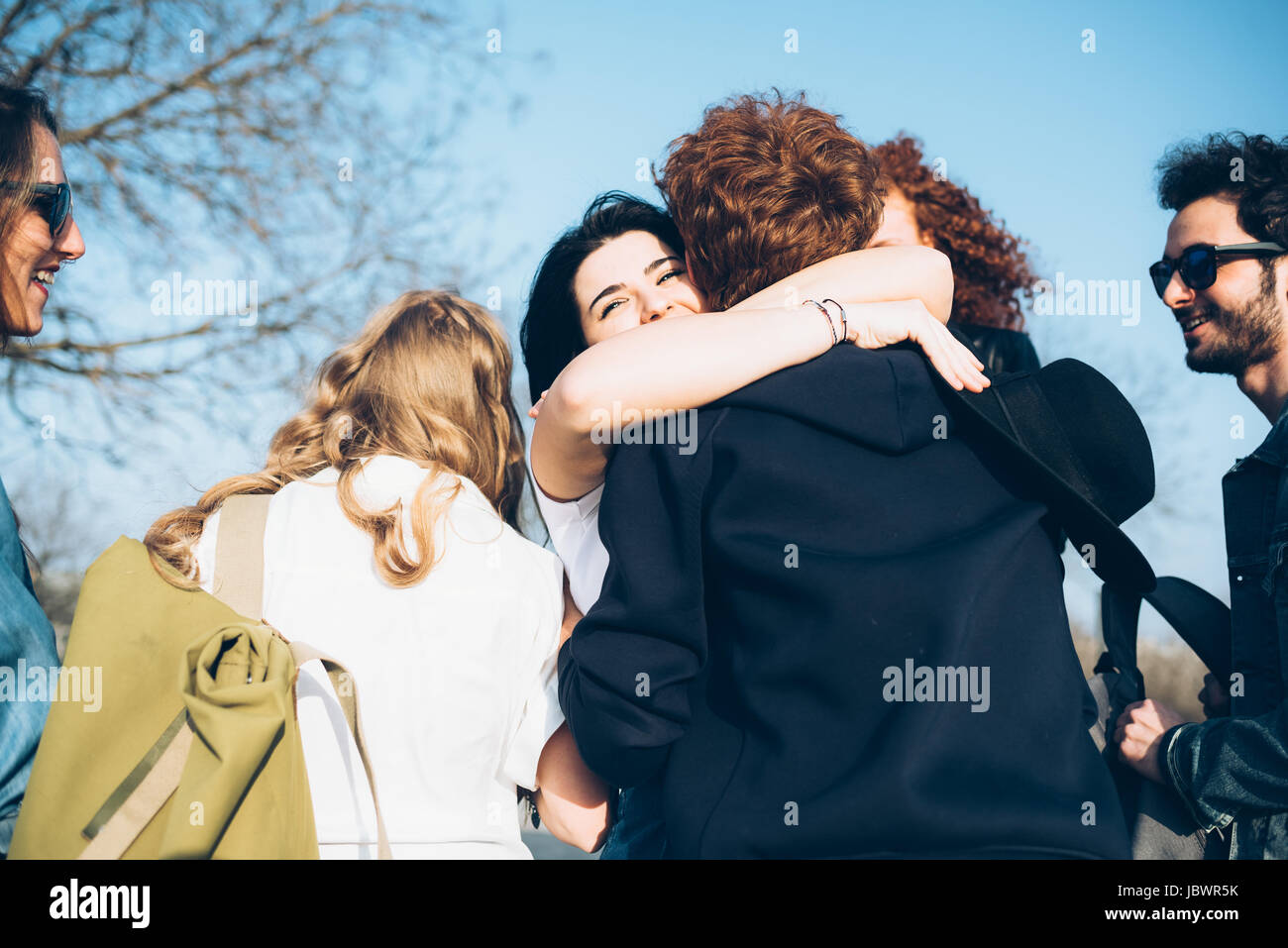 Group of friends hugging, outdoors Stock Photo - Alamy