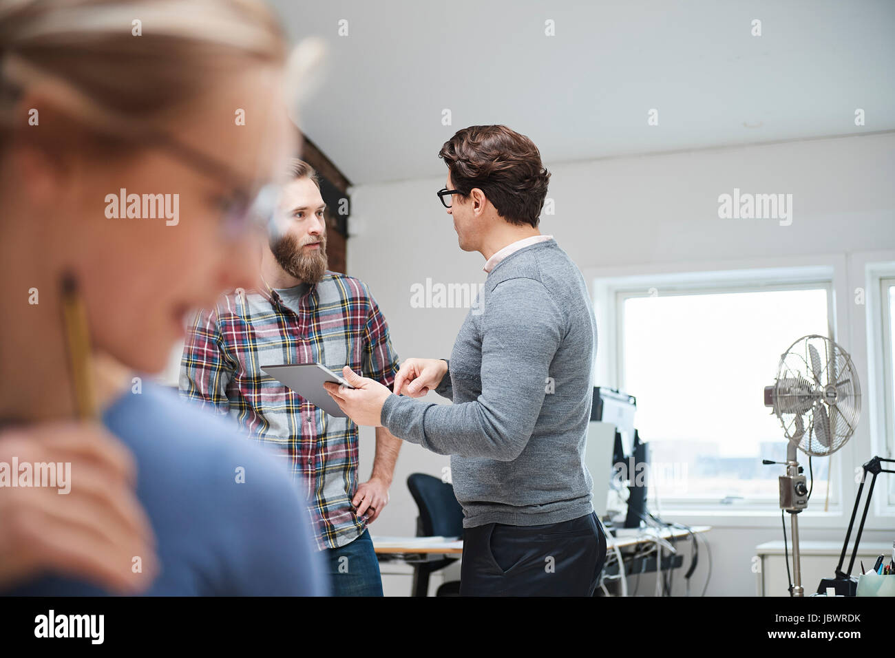 Male designers having discussion in design studio Stock Photo - Alamy