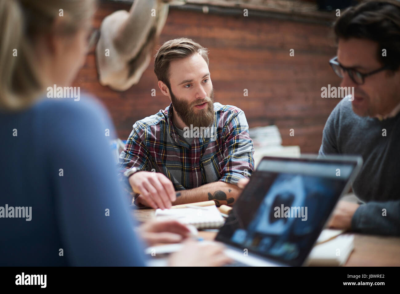 Design team having brainstorming meeting at design studio desk Stock ...