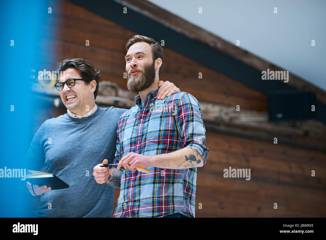 Two happy male designers in design studio Stock Photo - Alamy