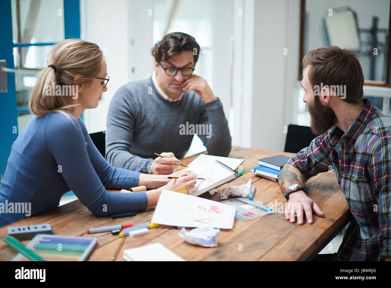 Design team having brainstorming meeting at design studio desk Stock ...