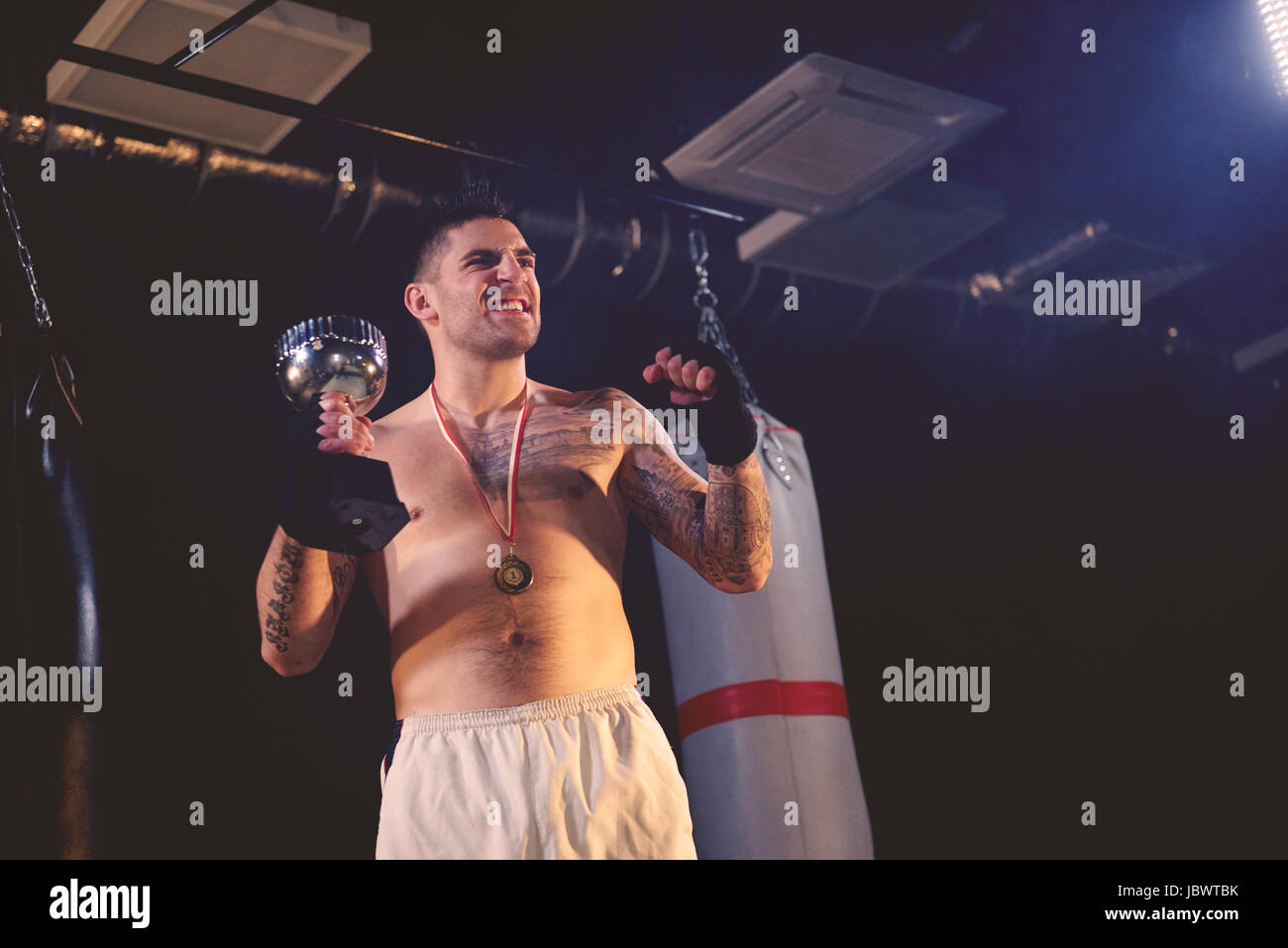 Boxing champion holding trophy Stock Photo - Alamy