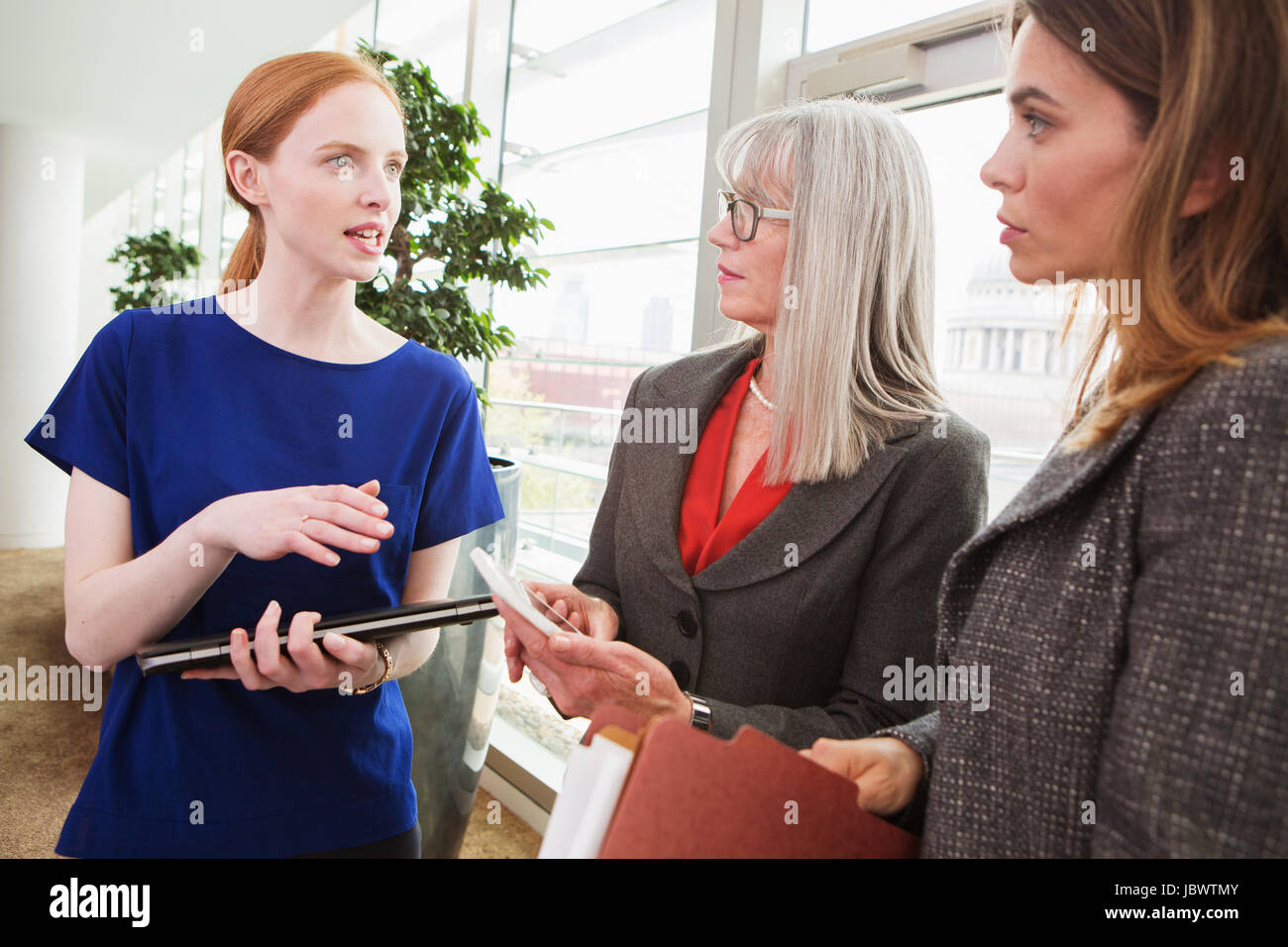 Businesswomen standing having discussion, London, UK Stock Photo - Alamy