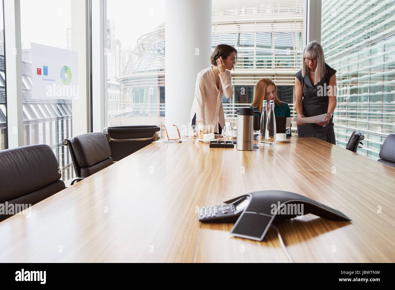 Businesswomen preparing presentation in meeting room Stock Photo - Alamy
