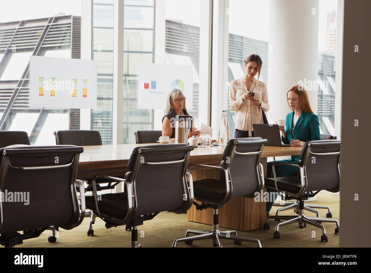 Businesswomen preparing presentation in meeting room Stock Photo - Alamy