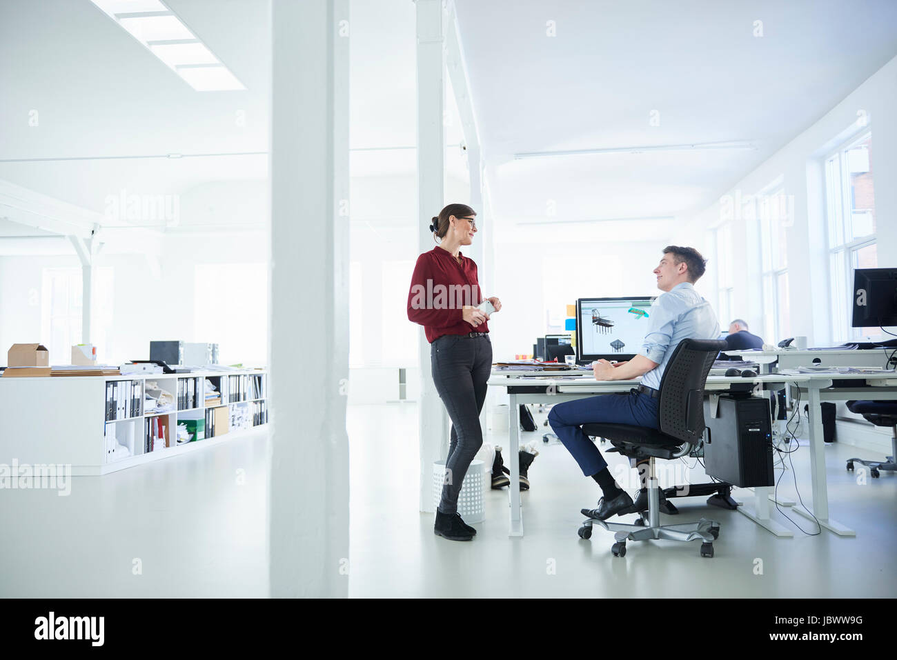 Colleagues collaborating open plan hi-res stock photography and images ...