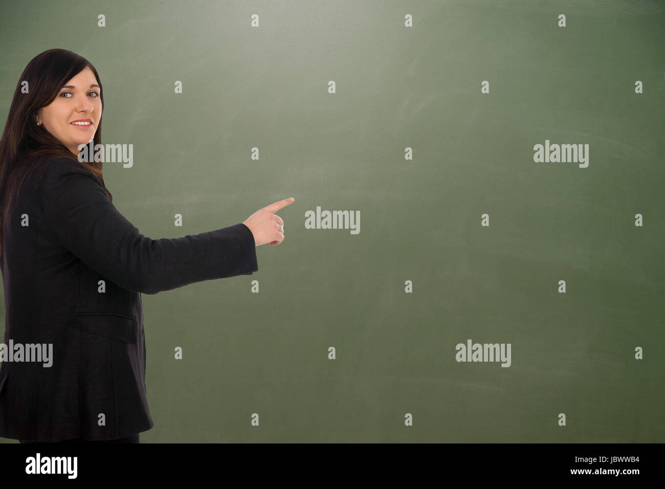 Teacher pointing at a blank school blackboard Stock Photo - Alamy