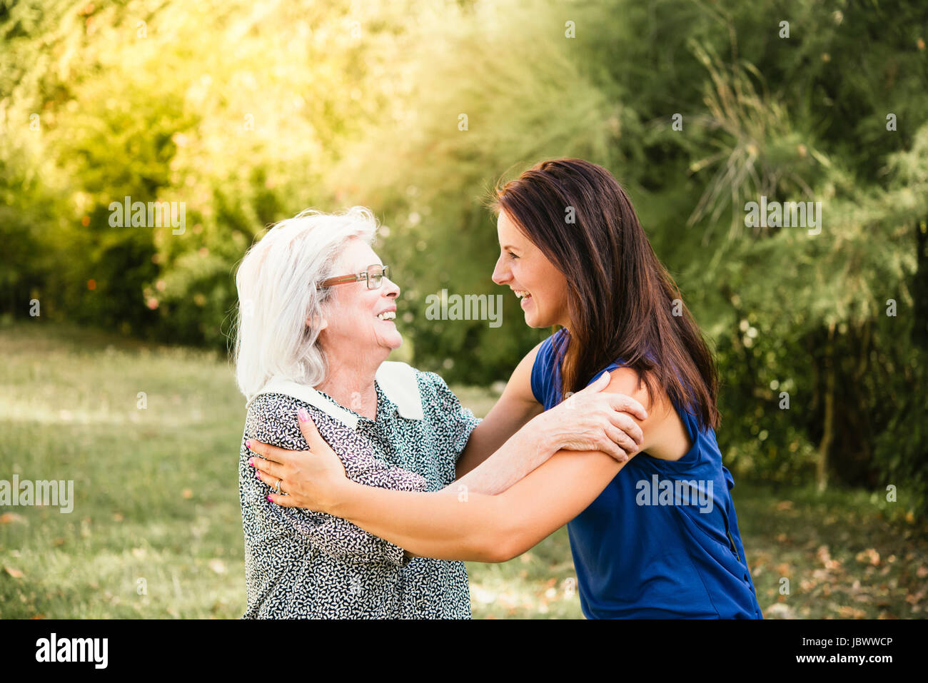 Senior woman, hugging granddaughter, outdoors Stock Photo - Alamy