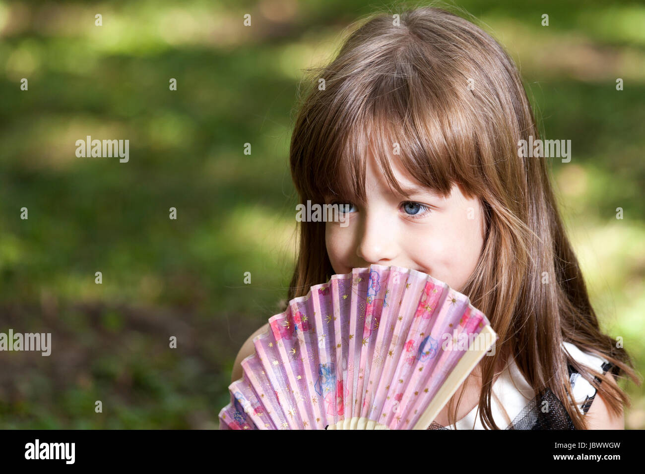 Portrait of a cute little girl with Chinese paper fan for cooling Stock ...