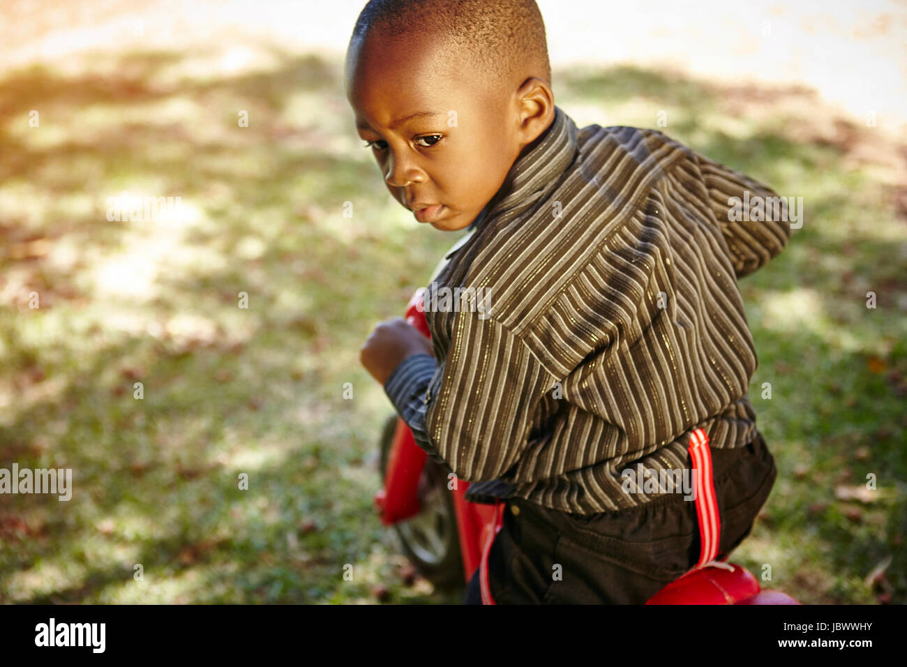 Boy riding motorcycle in park Stock Photo - Alamy
