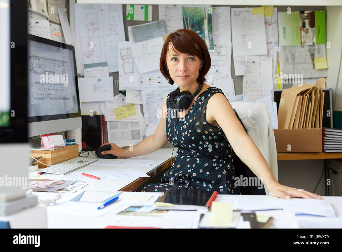 Portrait of female designer at office desk Stock Photo - Alamy