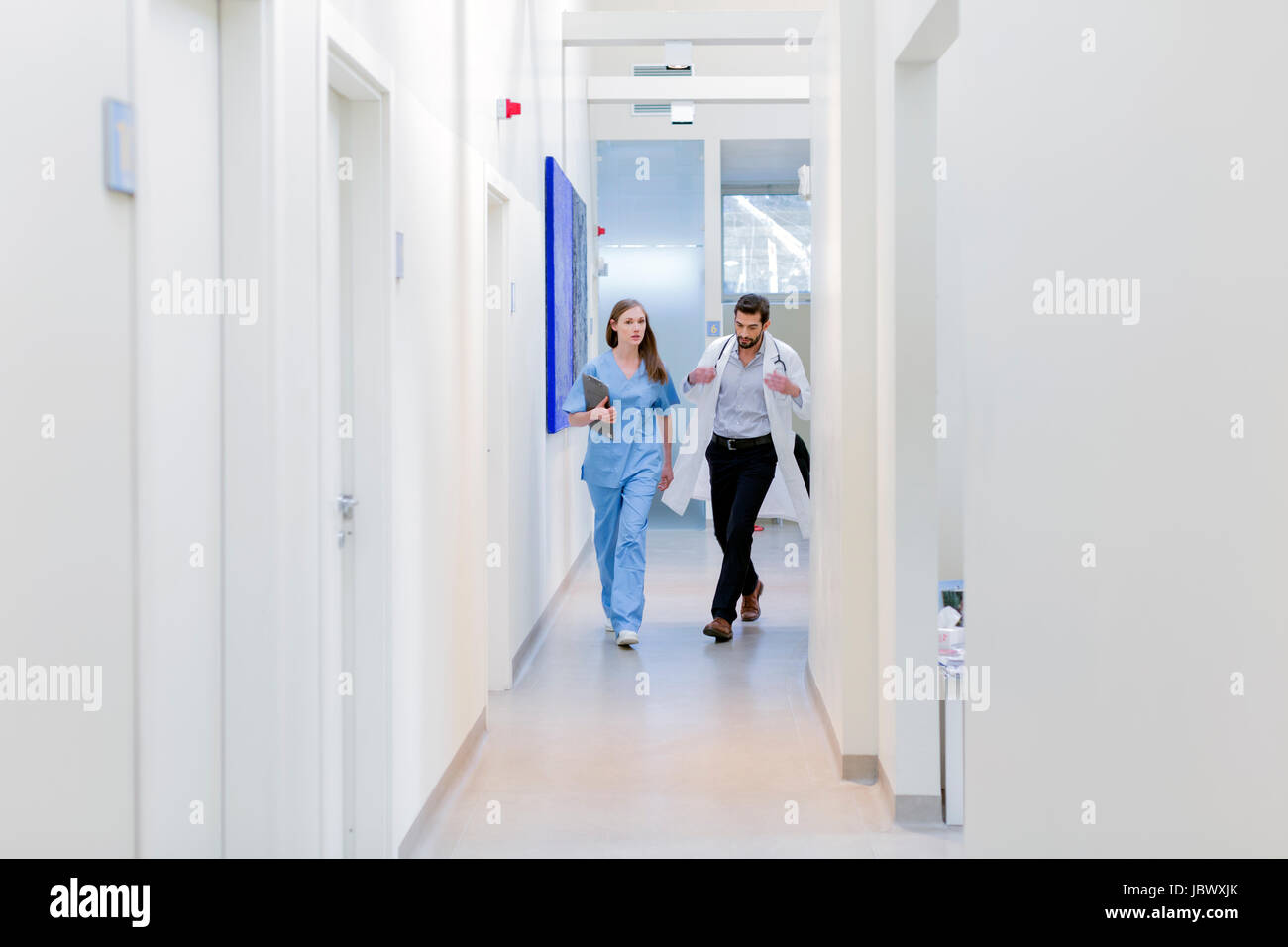 Doctors walking through hospital corridor Stock Photo - Alamy