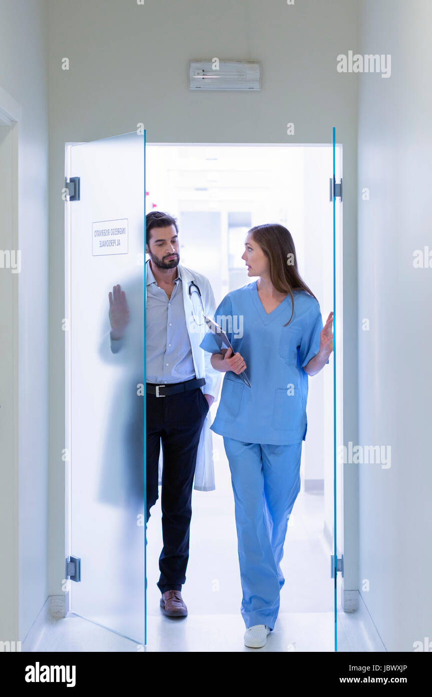 Doctors walking in hospital corridor Stock Photo - Alamy