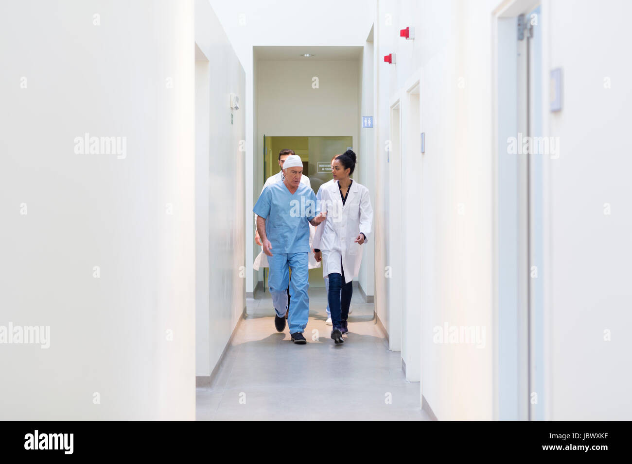 Doctors walking through hospital corridor Stock Photo - Alamy