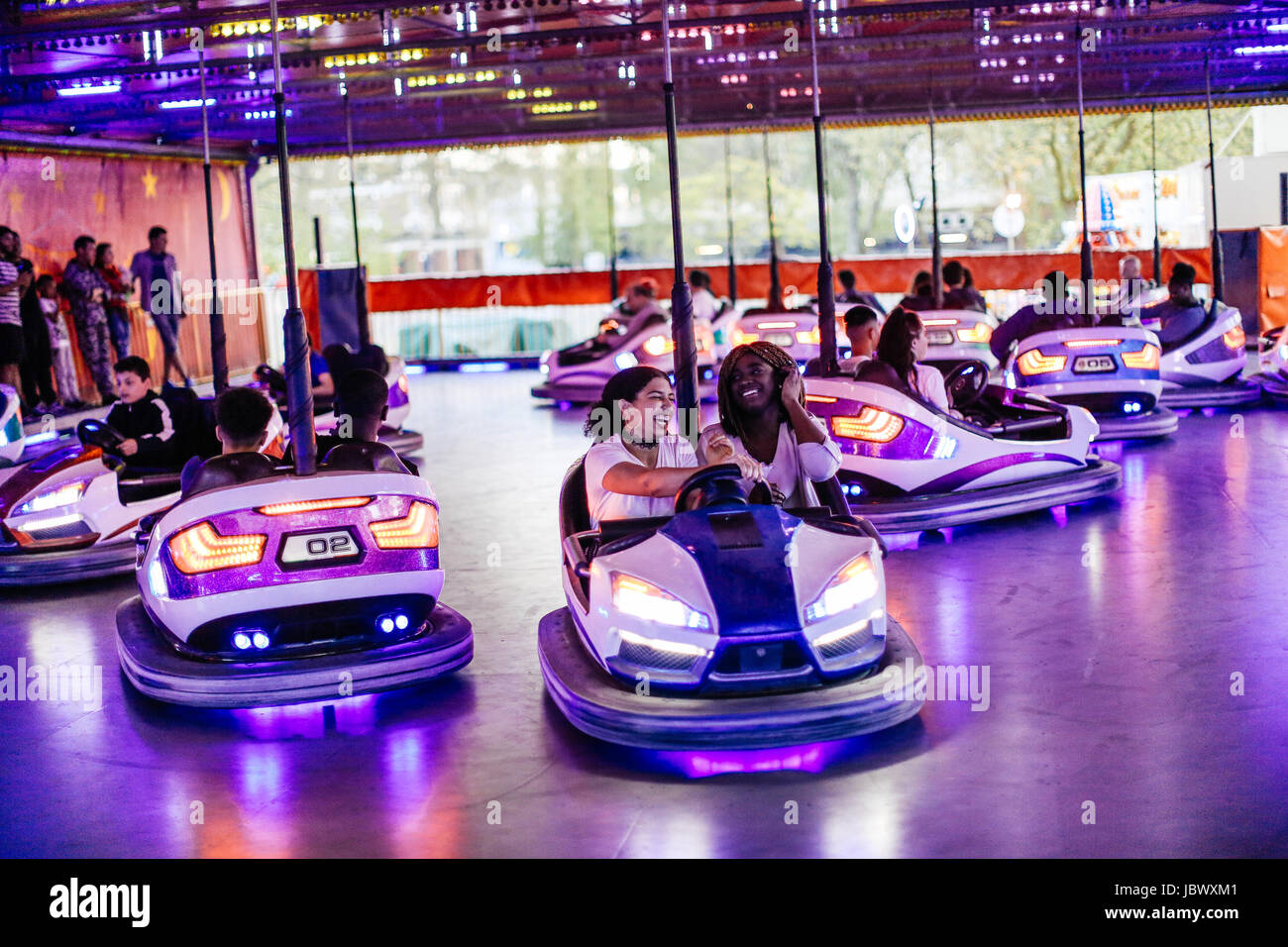 Group of friends at funfair, driving bumper cars Stock Photo - Alamy