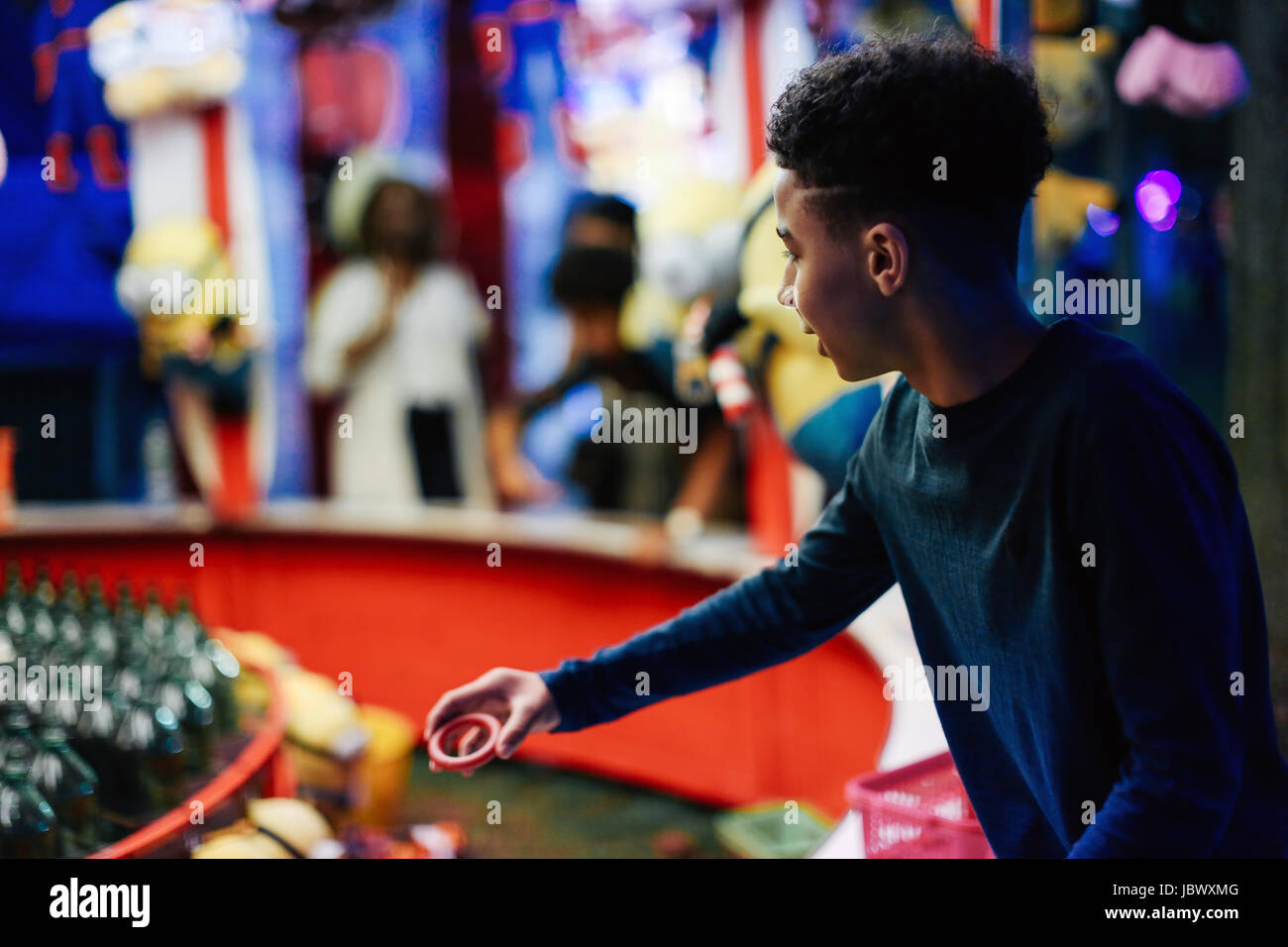 Young boy at funfair, playing on fairground stall Stock Photo - Alamy