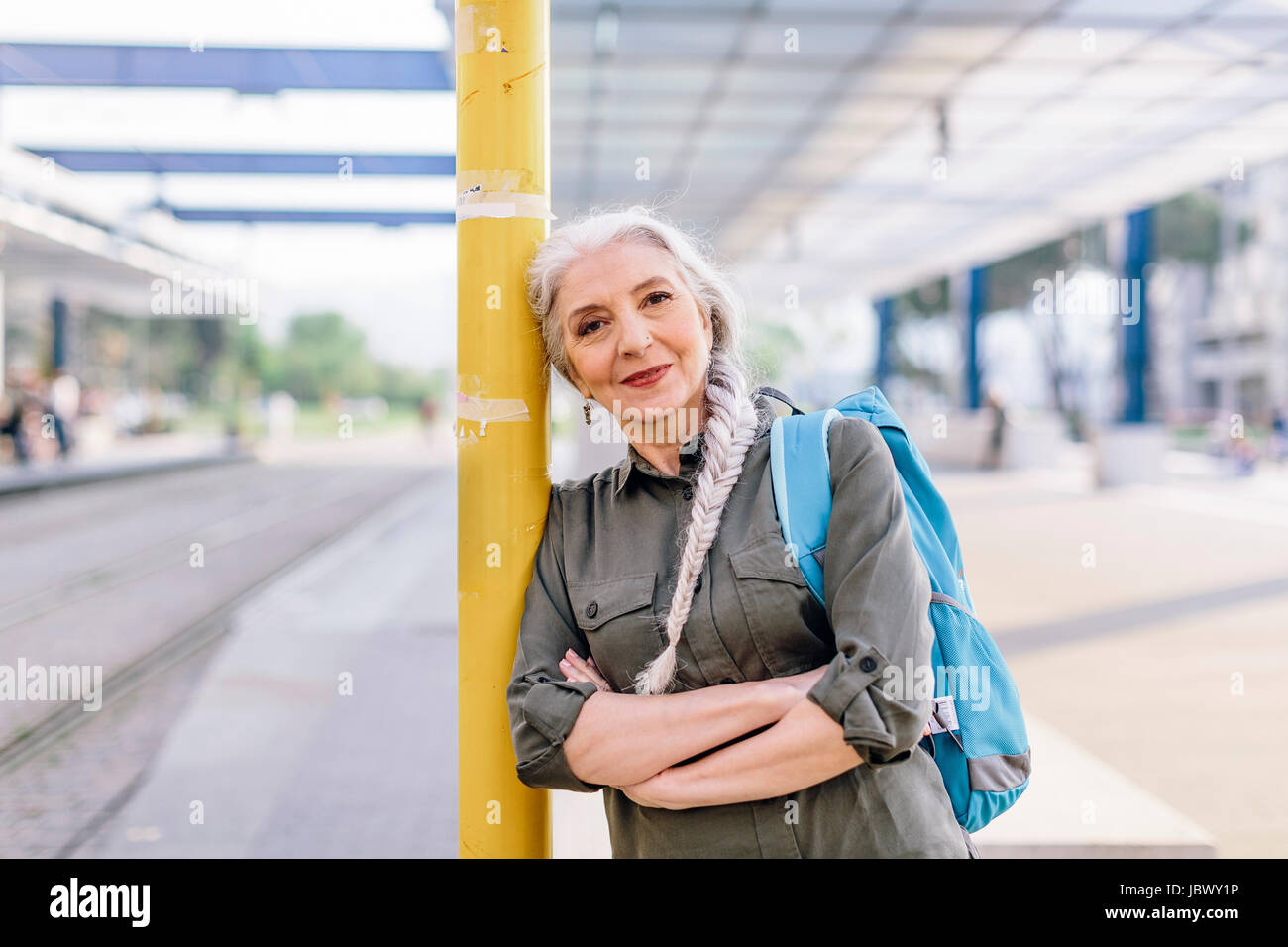 Portrait of mature female backpacker in bus station, Scandicci, Tuscany ...