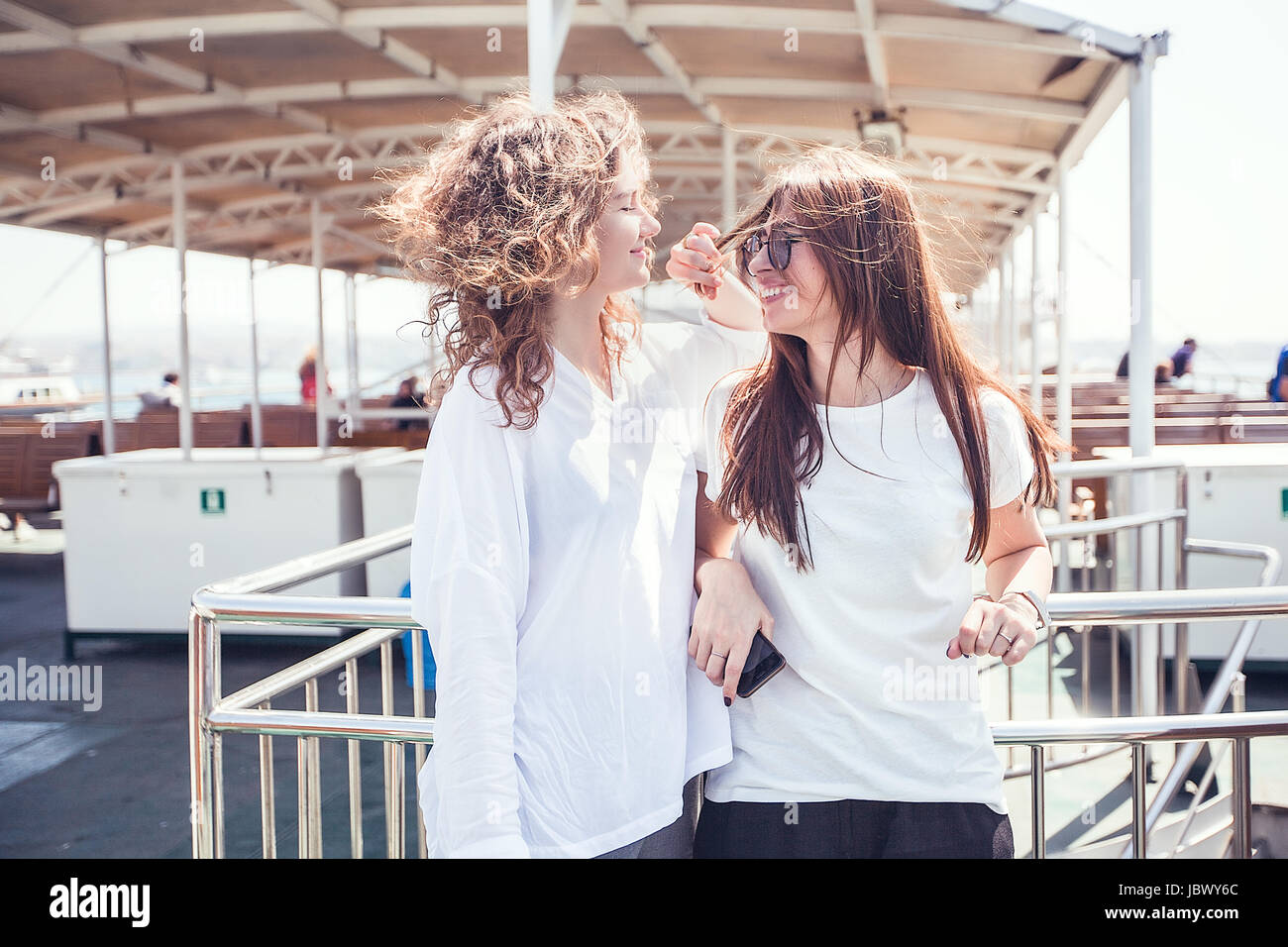 Two young female tourist friends on passenger ferry deck, Beyazit ...