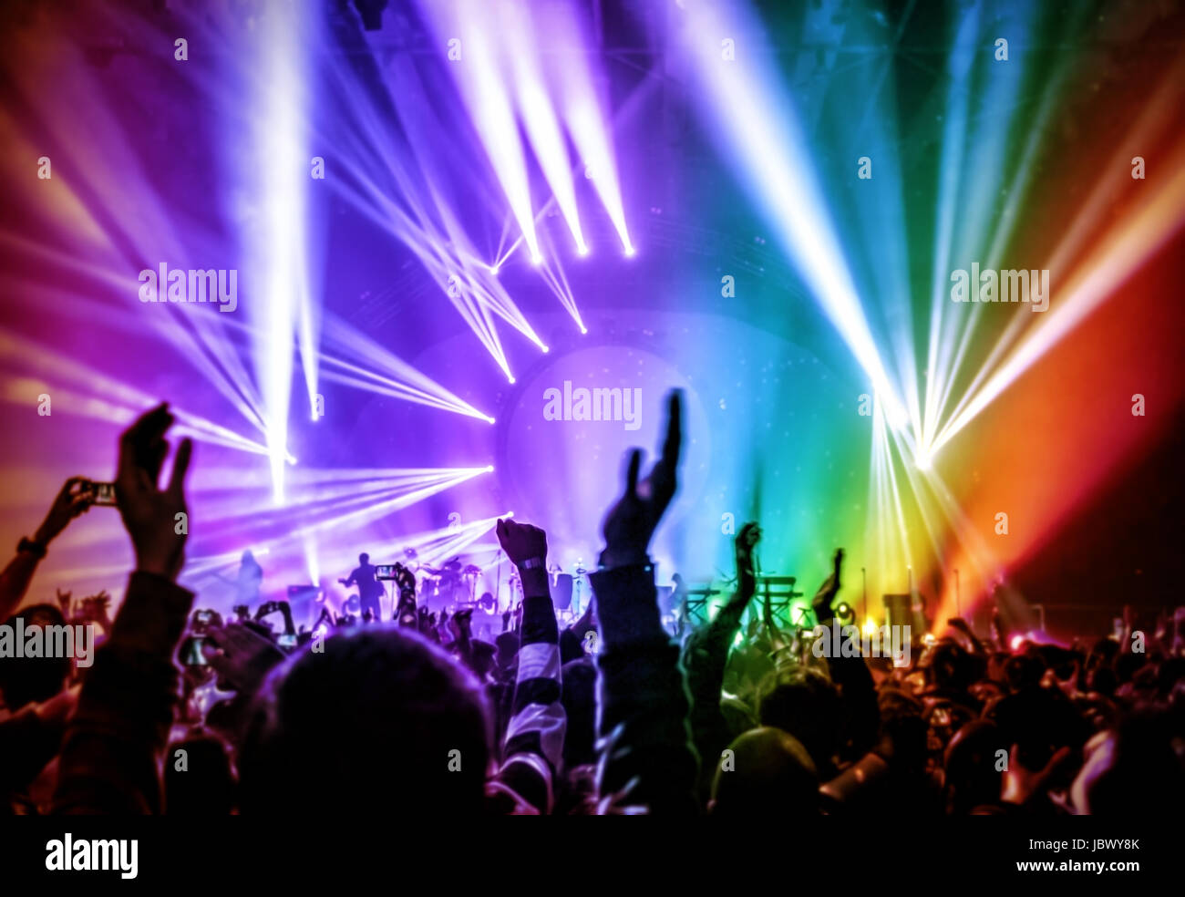 Happy young people having fun on rock concert in nightclub, colorful ...