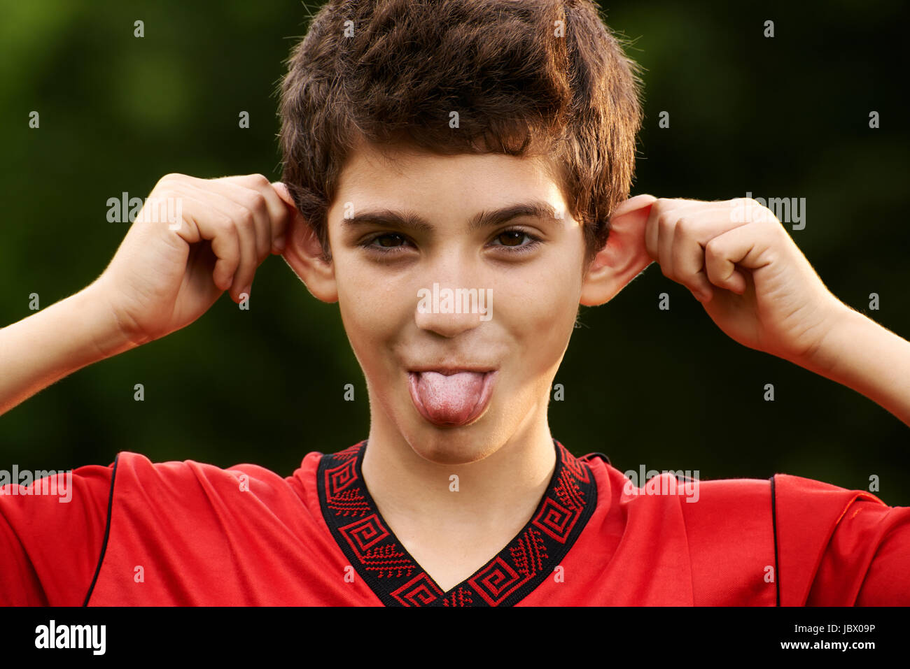Portrait of happy hispanic child making a face and grimacing at camera ...