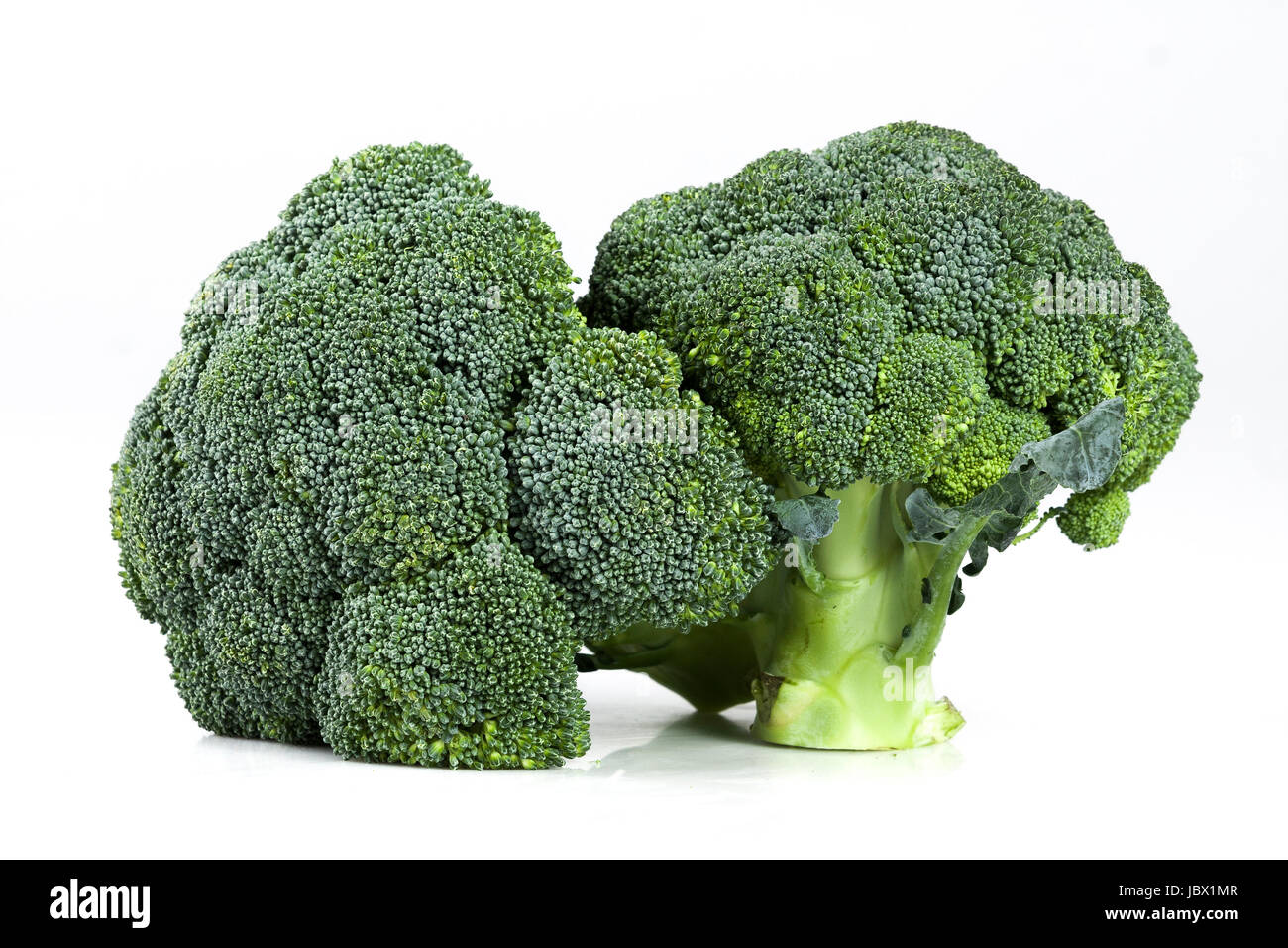 Two fresh ripe broccoli heads isolated on white background Stock Photo ...