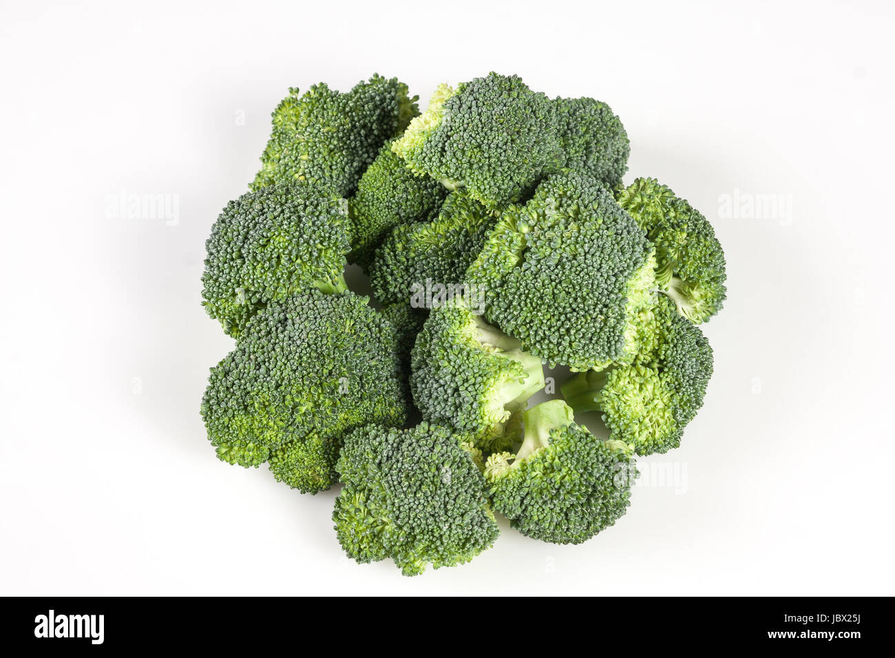 Bunch of broccoli pieces isolated on white background Stock Photo - Alamy