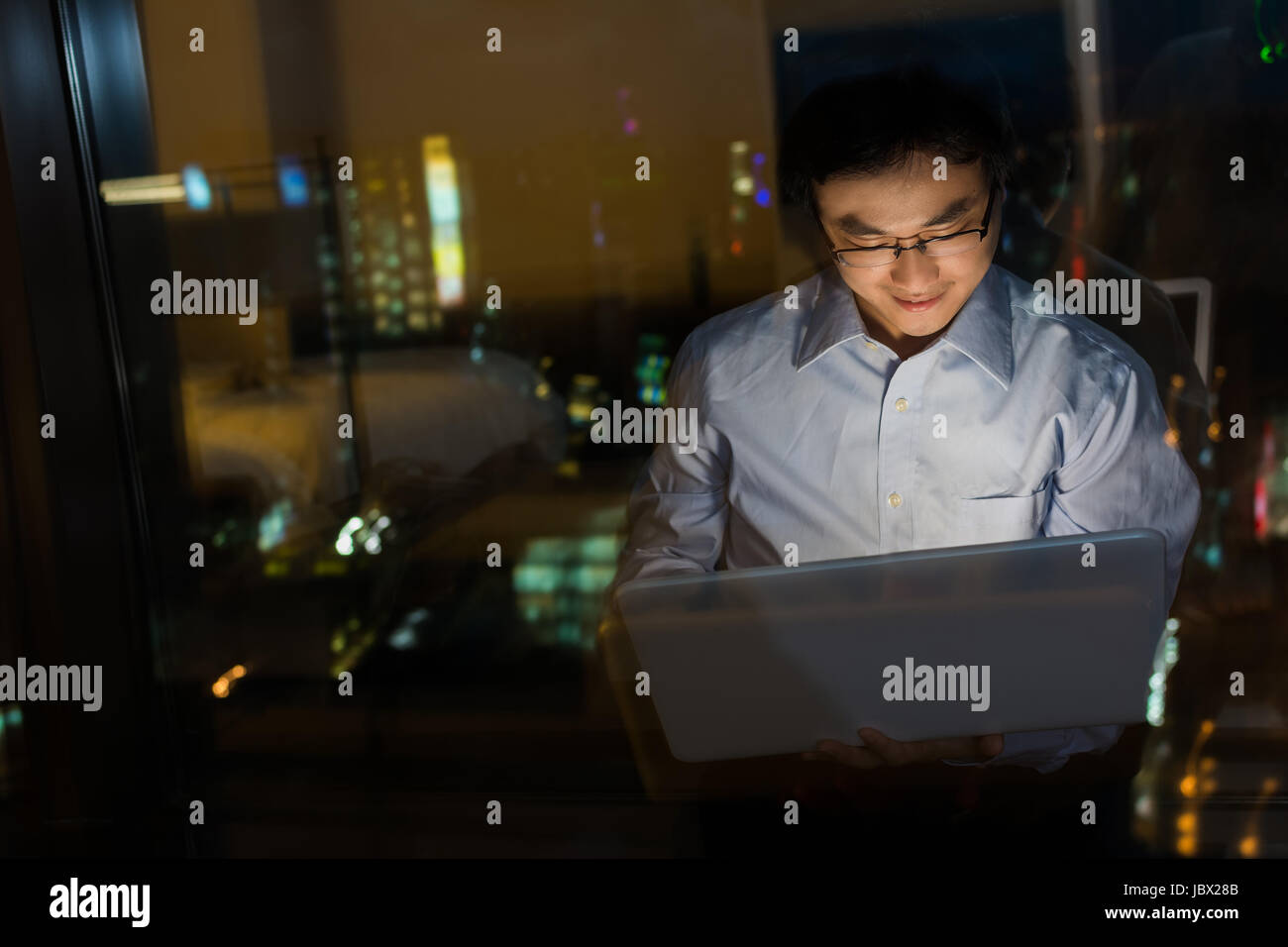 Asian man work at night in the office Stock Photo - Alamy