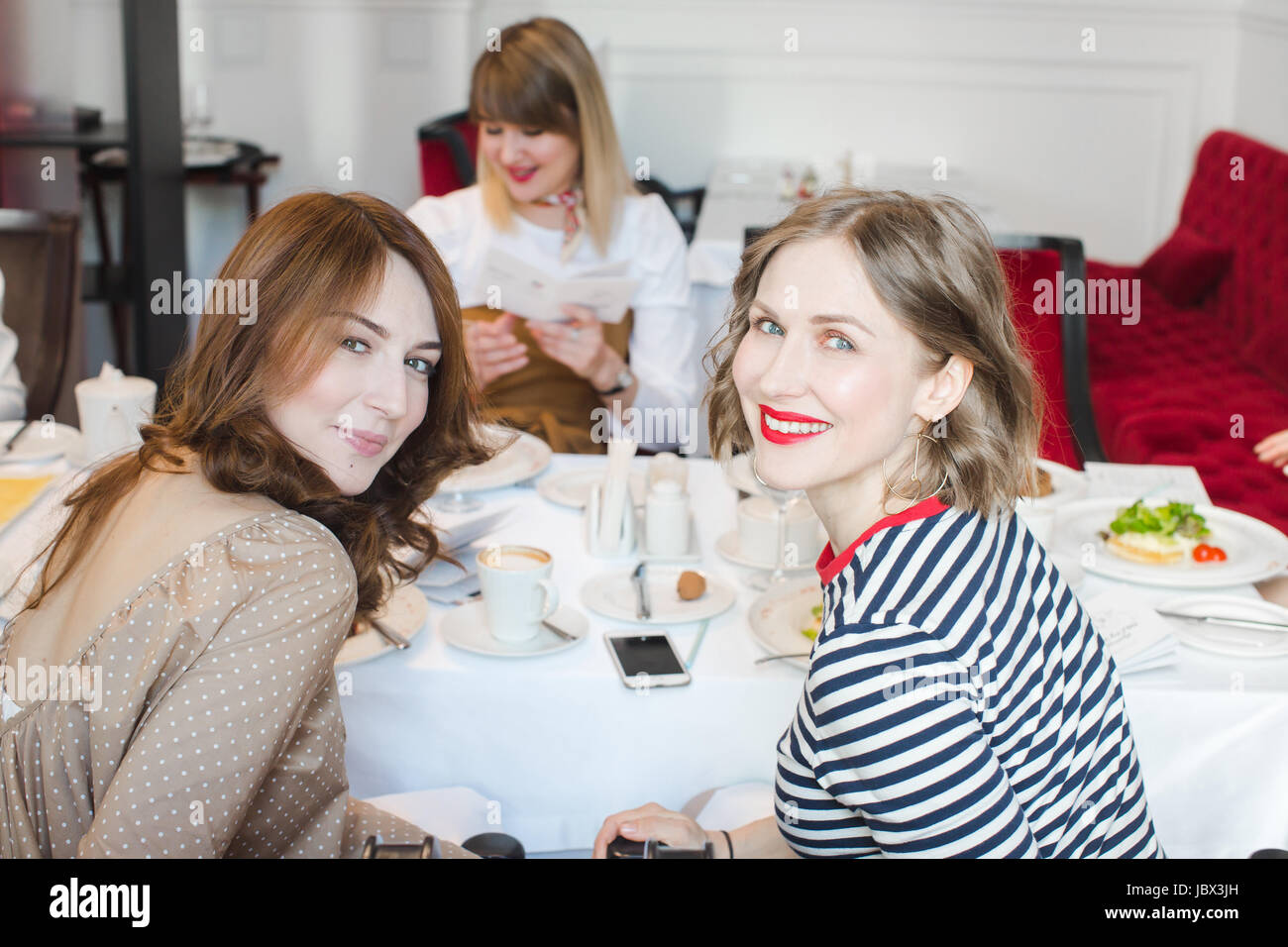 Elegant women in restaurant Stock Photo - Alamy