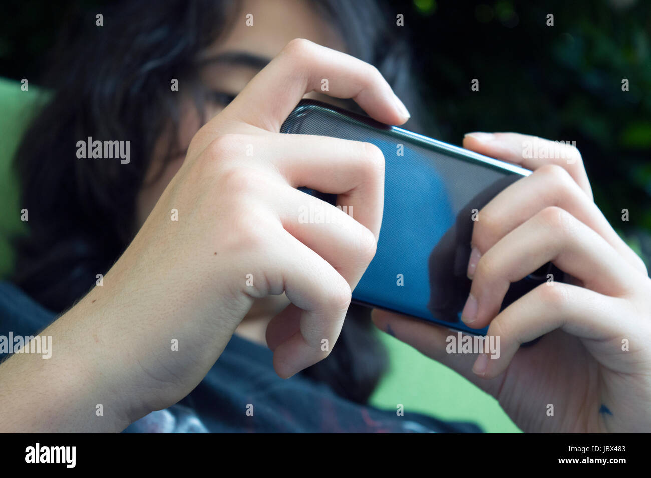 A modern mobile phone held in hands by a teenage boy Stock Photo - Alamy