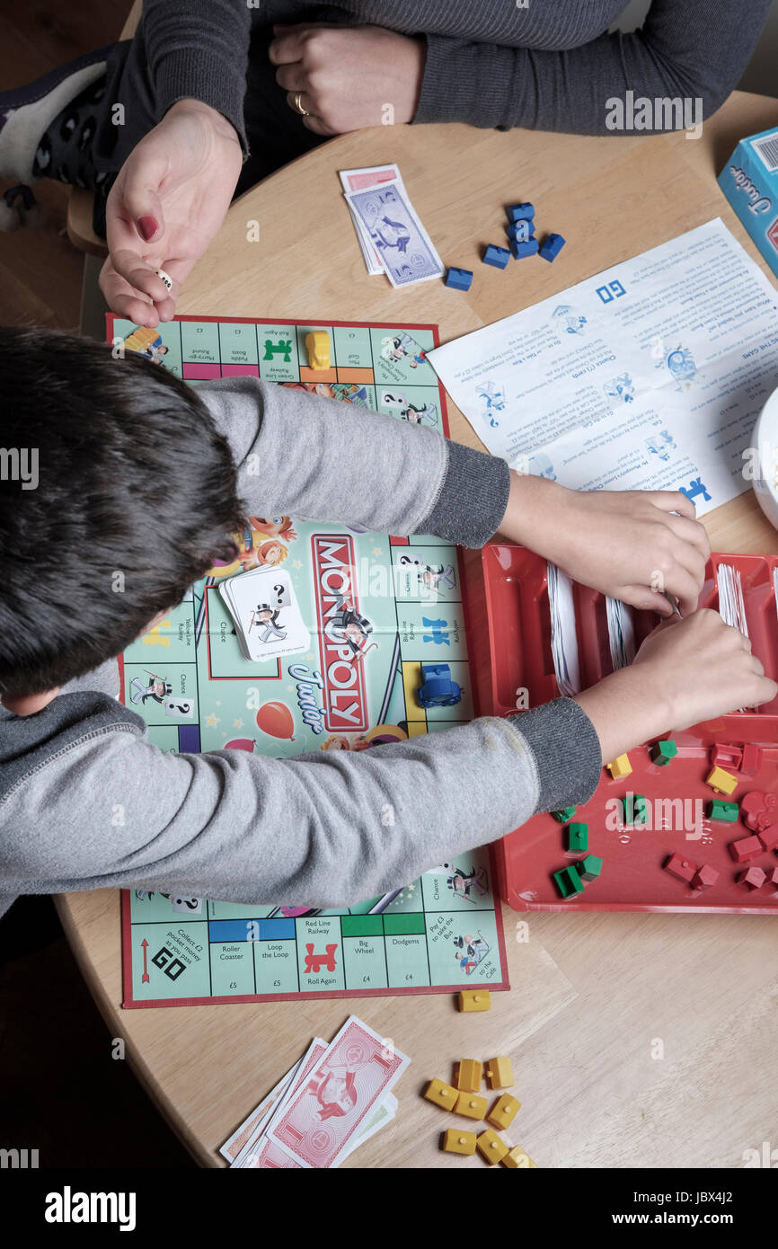 Mother and child playing monopoly board game Stock Photo - Alamy