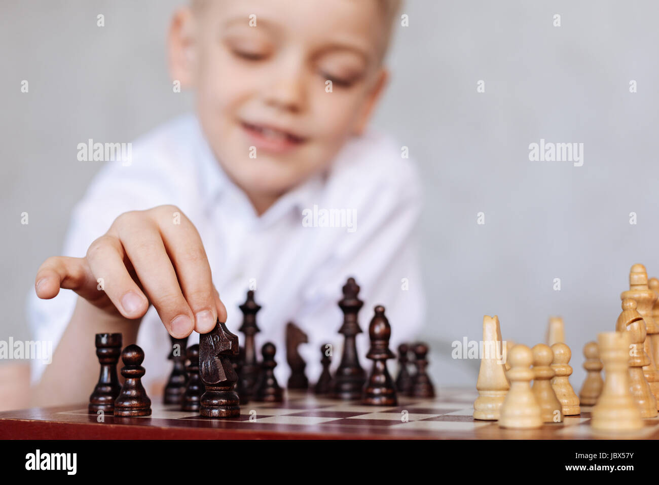 Curious focused kid making his move Stock Photo - Alamy