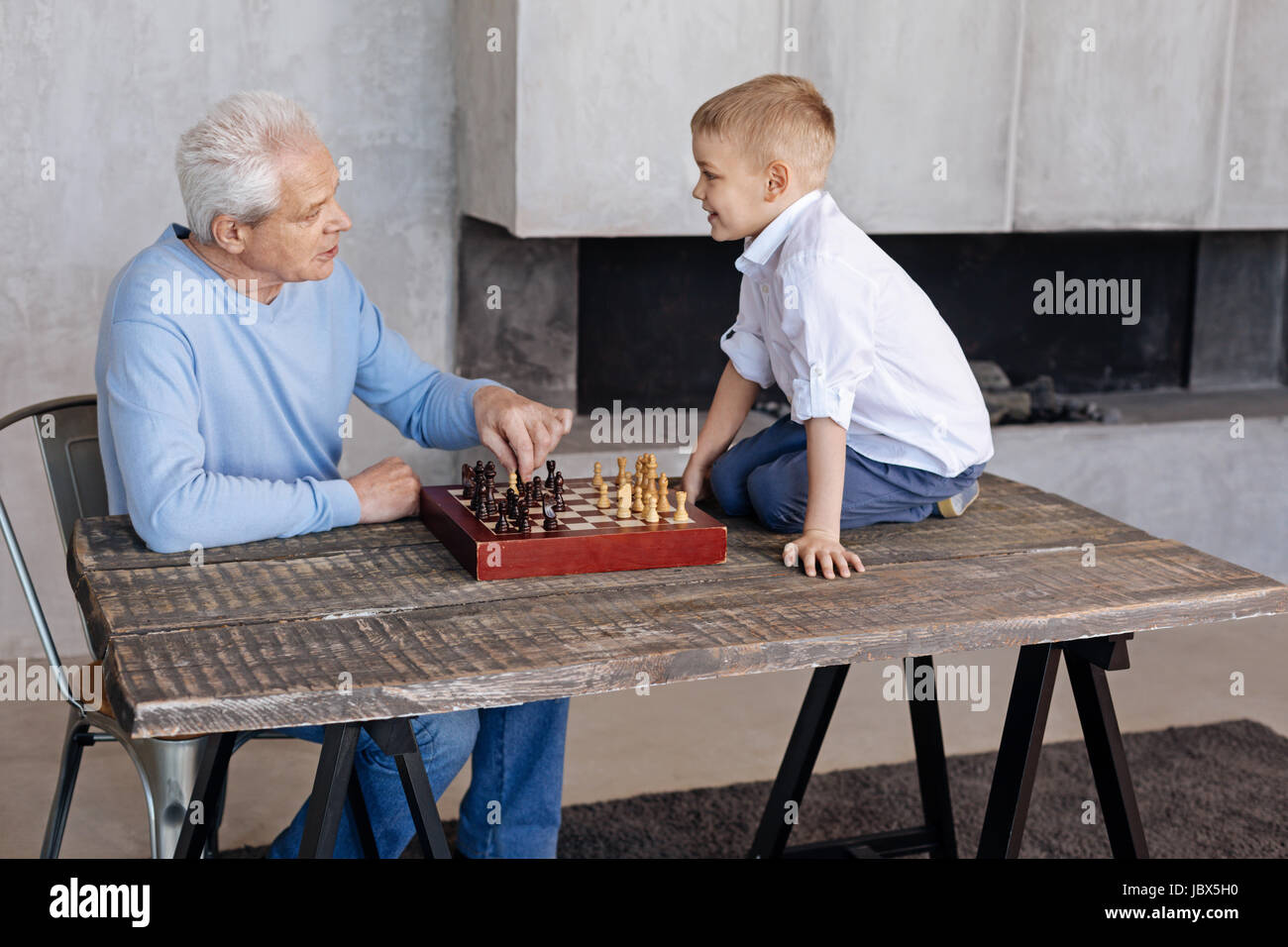 Excited attentive boy listening to his grandparents lecture Stock Photo ...