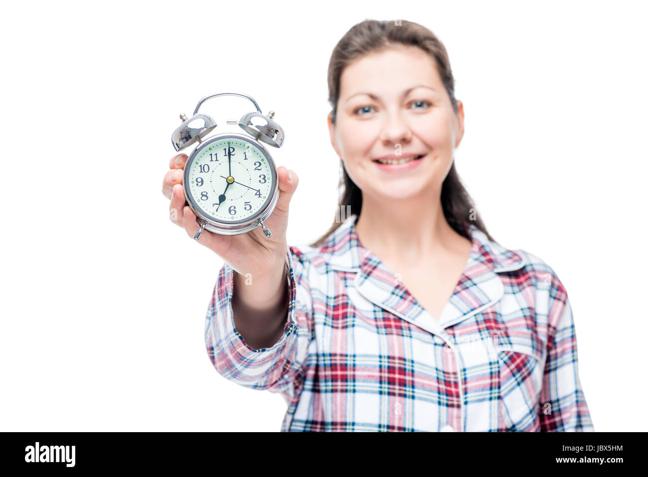 7 am on the dial of an alarm clock in a female hand, an alarm clock in ...