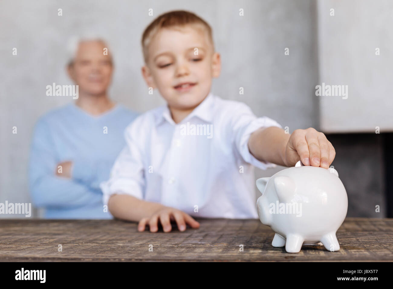 Inspired young kid sparing money for a dream Stock Photo - Alamy