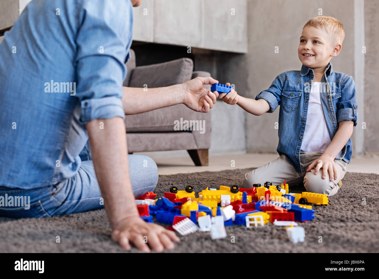 Productive intelligent boy enjoying a creative game with grandpa Stock ...