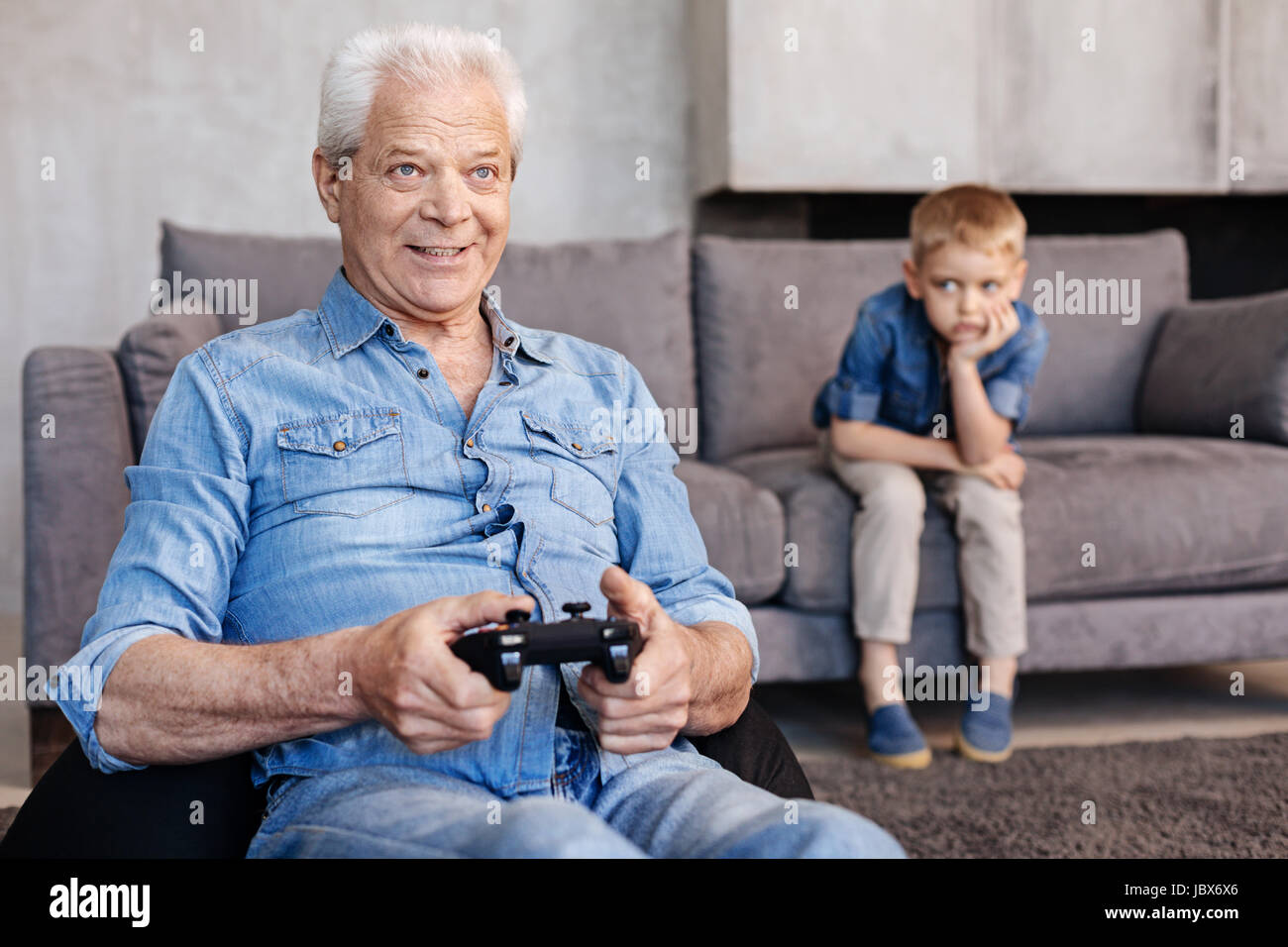 Sad curious kid waiting for his turn Stock Photo - Alamy