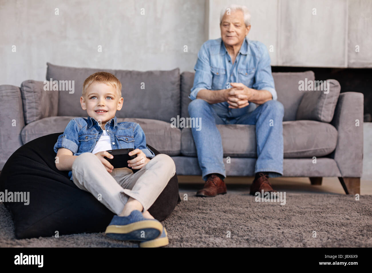 Observant attentive man watching his grandson playing Stock Photo - Alamy