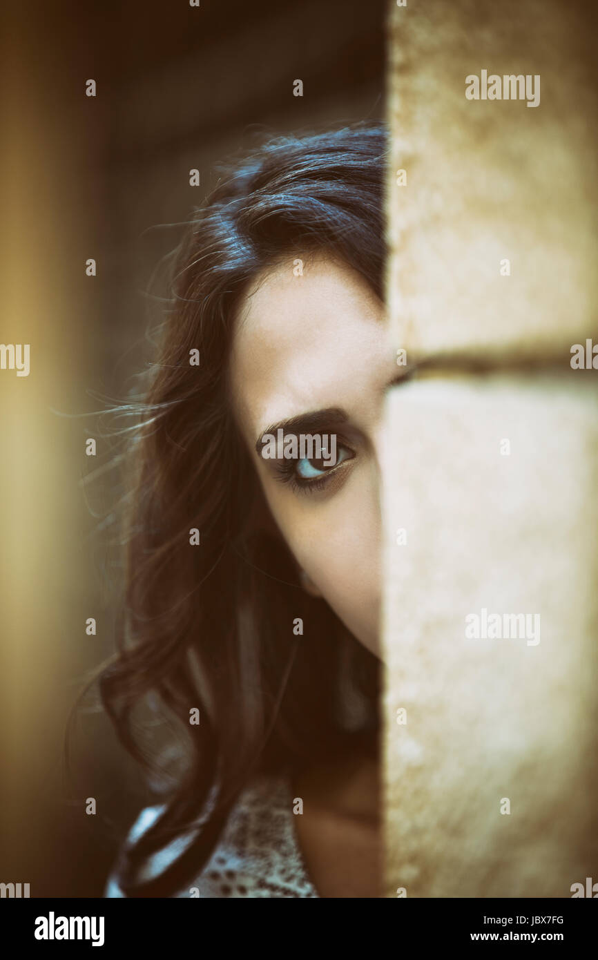 Scared young woman in danger hiding Stock Photo - Alamy