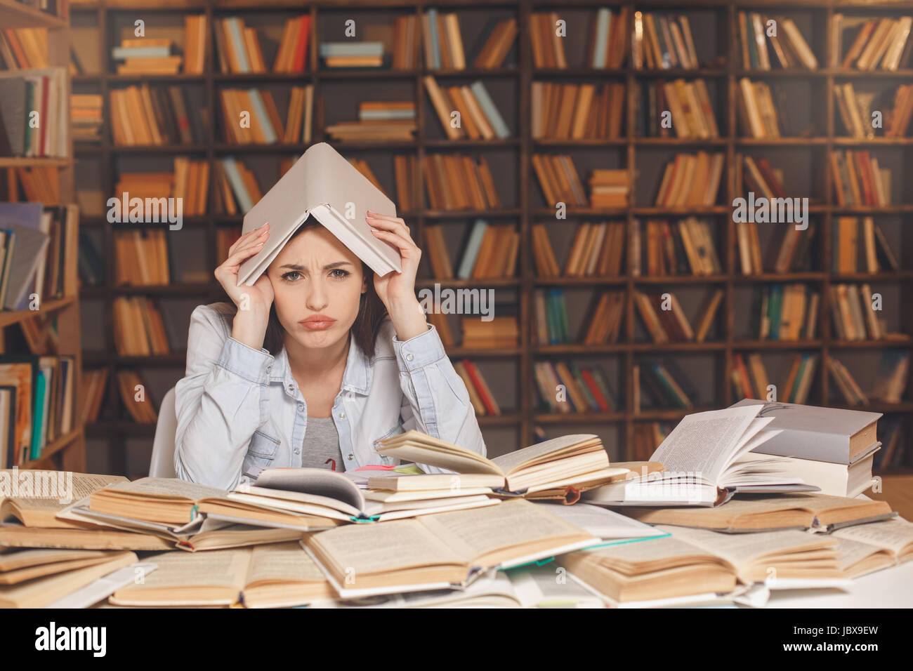 Young female study in the library upset Stock Photo - Alamy