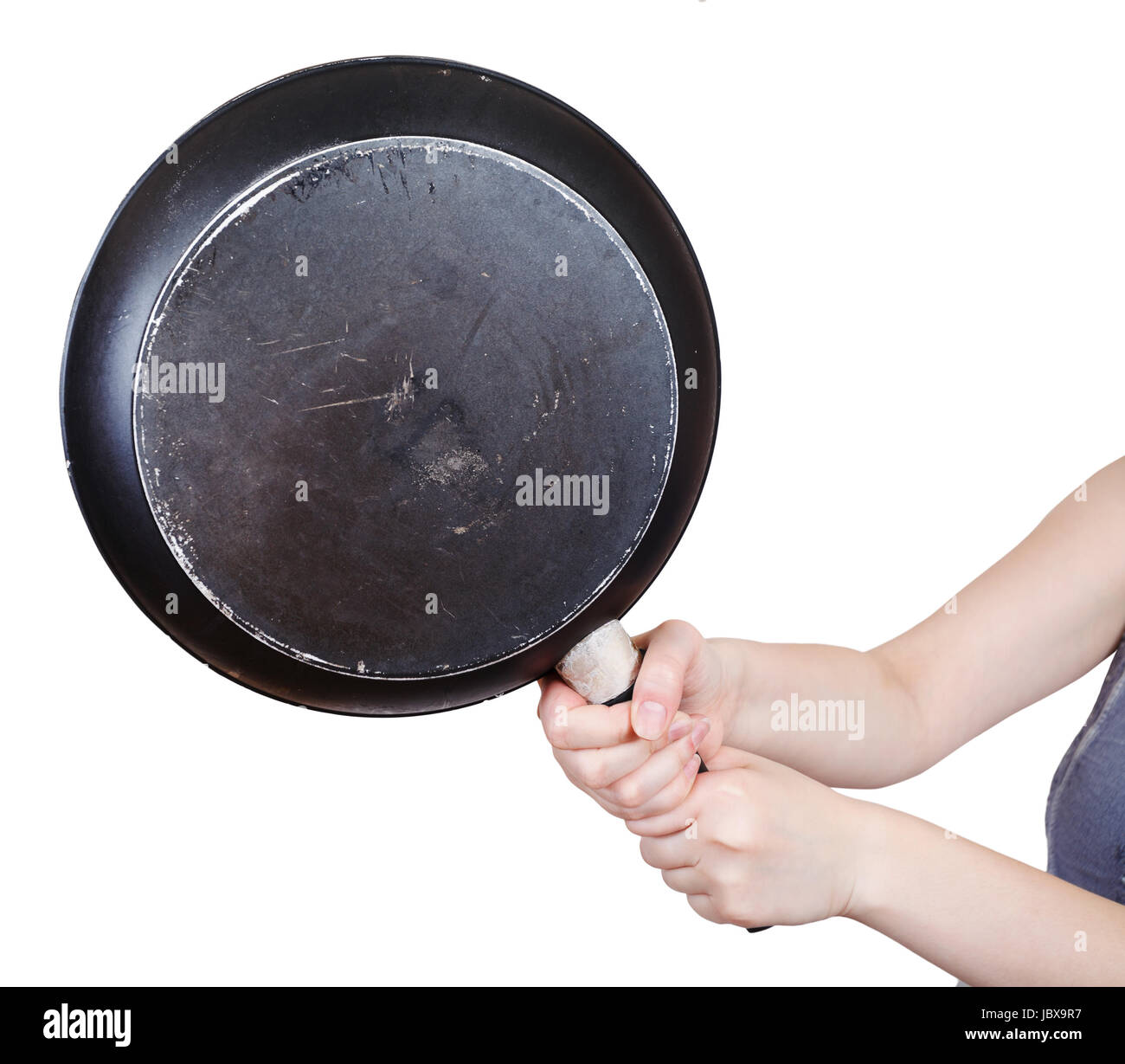 black frying pan in female hands close up isolated on white background ...